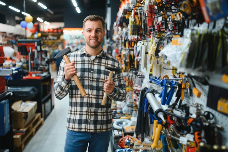 A Male Buyer in a Modern Hardware Store Chooses a Hammer Stock Image ...