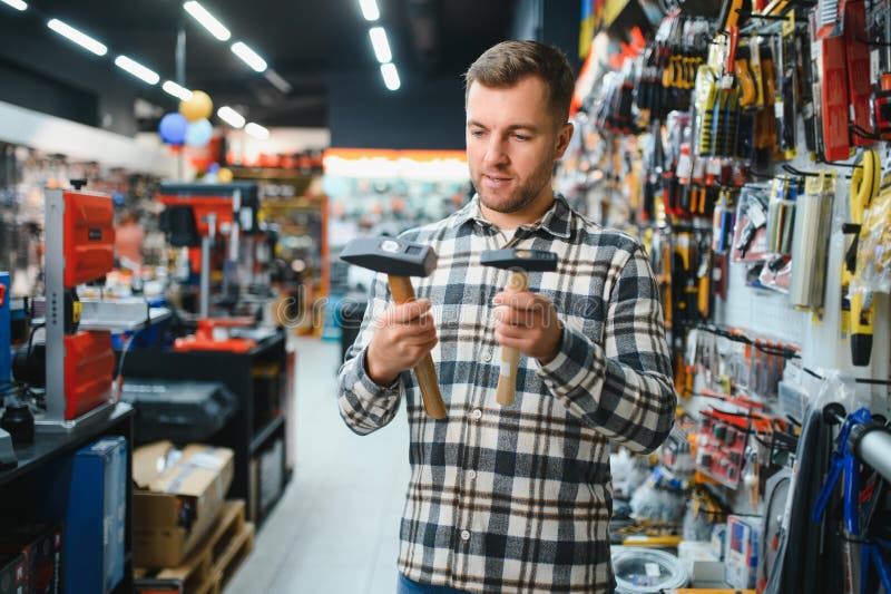 A Male Buyer in a Modern Hardware Store Chooses a Hammer Stock Image ...