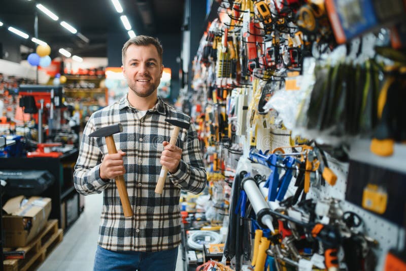 A Male Buyer in a Modern Hardware Store Chooses a Hammer Stock Image ...