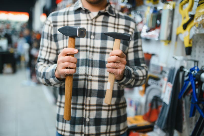 A Male Buyer in a Modern Hardware Store Chooses a Hammer Stock Photo ...
