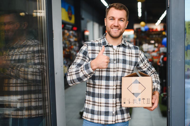 A Male Buyer in a Modern Hardware Store. a Large Selection of Tools and ...