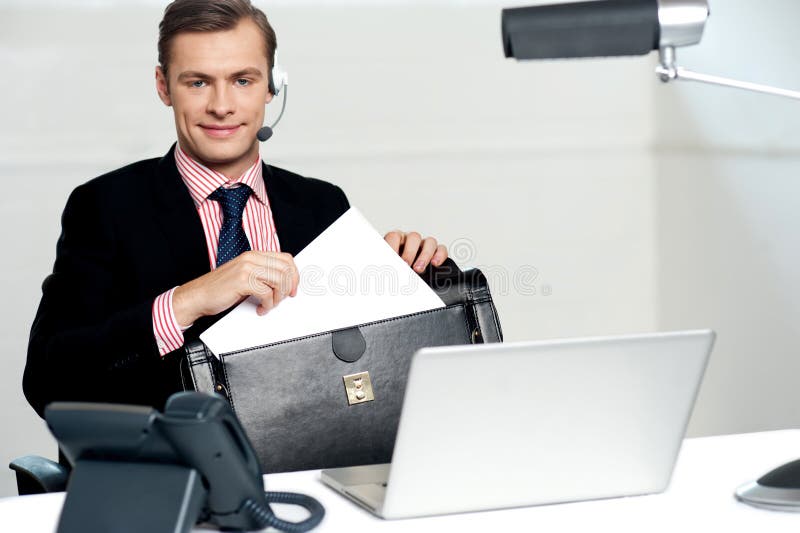Male Call Centre Executive Arranging Paper Works Stock Photo - Image of ...