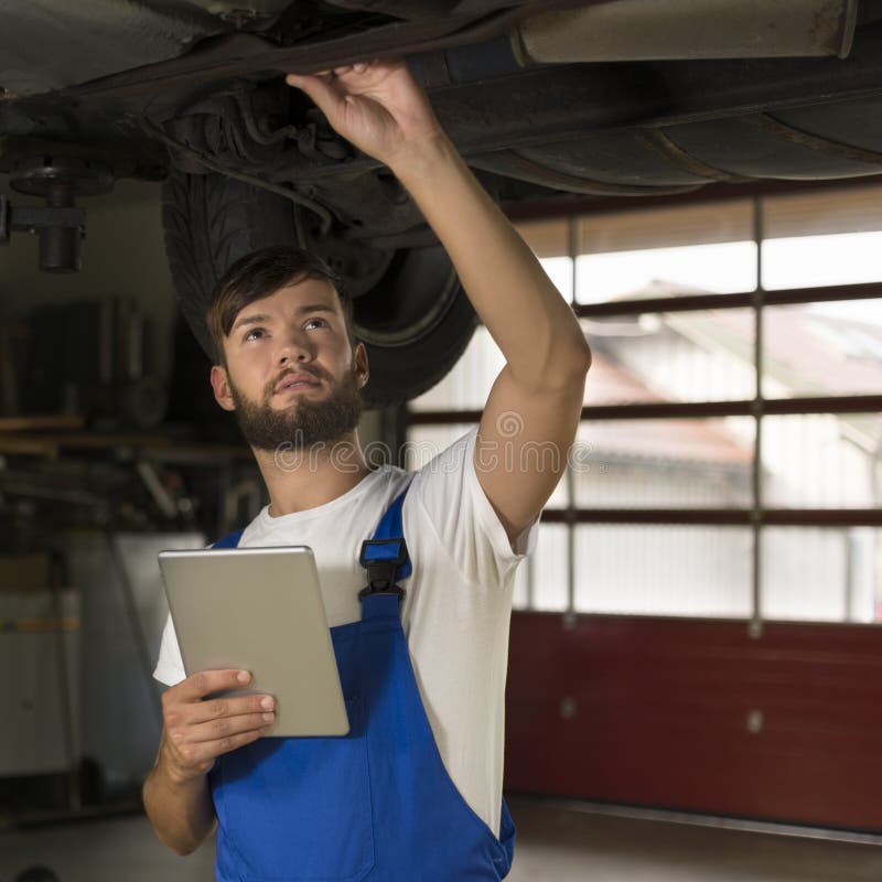 Male Car Mechanic Working Under Car with Tablet PC Stock Photo - Image ...