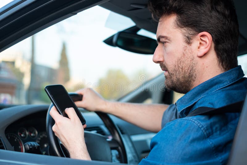 Male in Car Using Mobile Phone at the Wheel Stock Image - Image of ...