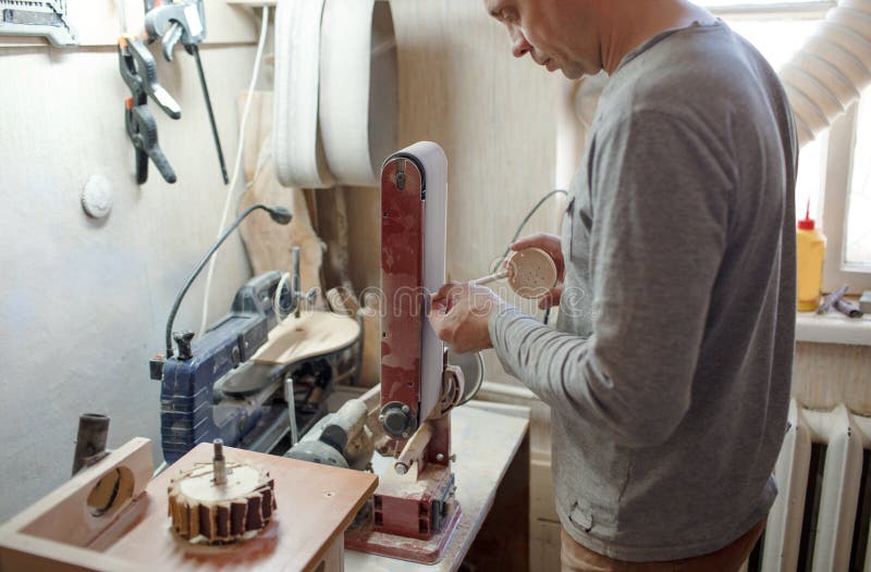 A Carpenter Grinds an Oak Plank Part with a Hand Grinder Stock Photo ...
