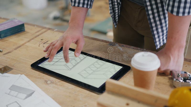 Male Carpenter Looking at Technical Drawings of Furniture on Tablet ...