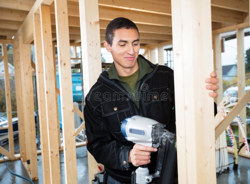 Male Carpenter Nailing Wood Stock Image - Image of pneumatic, manual ...