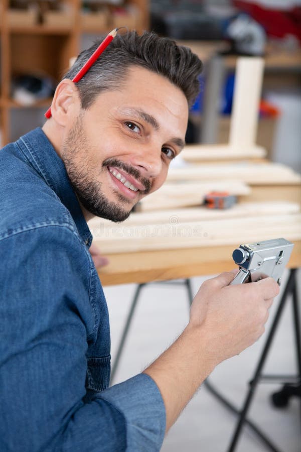 Male Carpenter Using Staple Gun Stock Photo - Image of equipment ...