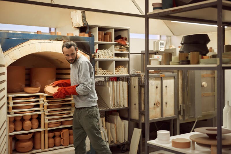 Ceramist Removing Clay Plates from a Workshop Kiln Stock Photo - Image ...