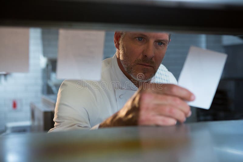 Male chef reading an order stock image. Image of kitchen - 102566865