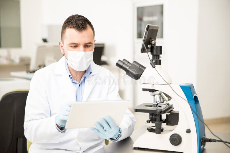 Male Chemist Using Technology in a Lab Stock Image - Image of ...