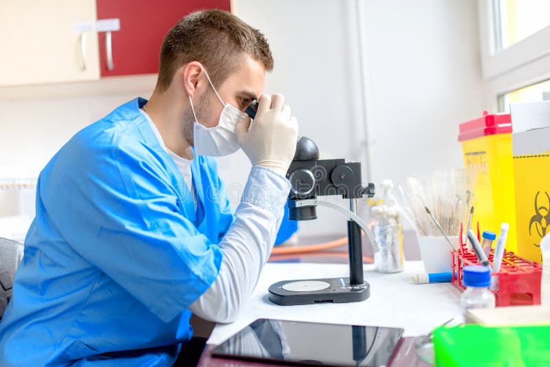 Male Chemist Working with Microscope in Laboratory Stock Photo - Image ...