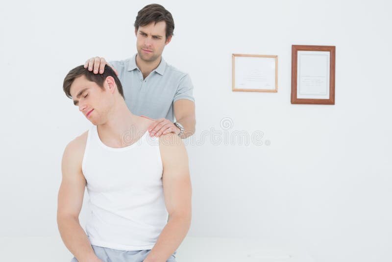 Male Chiropractor Doing Neck Adjustment Stock Image - Image of patient ...