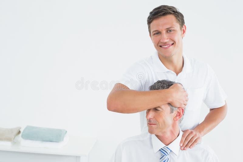 Male Chiropractor Doing Neck Adjustment Stock Image - Image of view ...