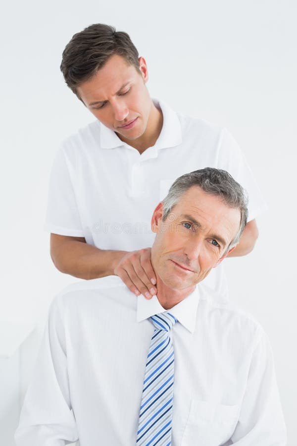 Male Chiropractor Massaging Patients Neck Stock Image - Image of ...