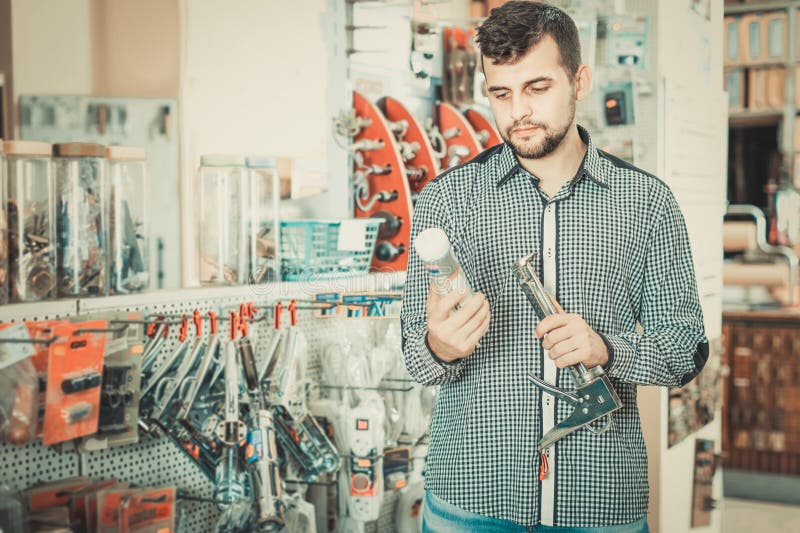 Male Choosing New Glue in Houseware Shop Stock Photo - Image of ...