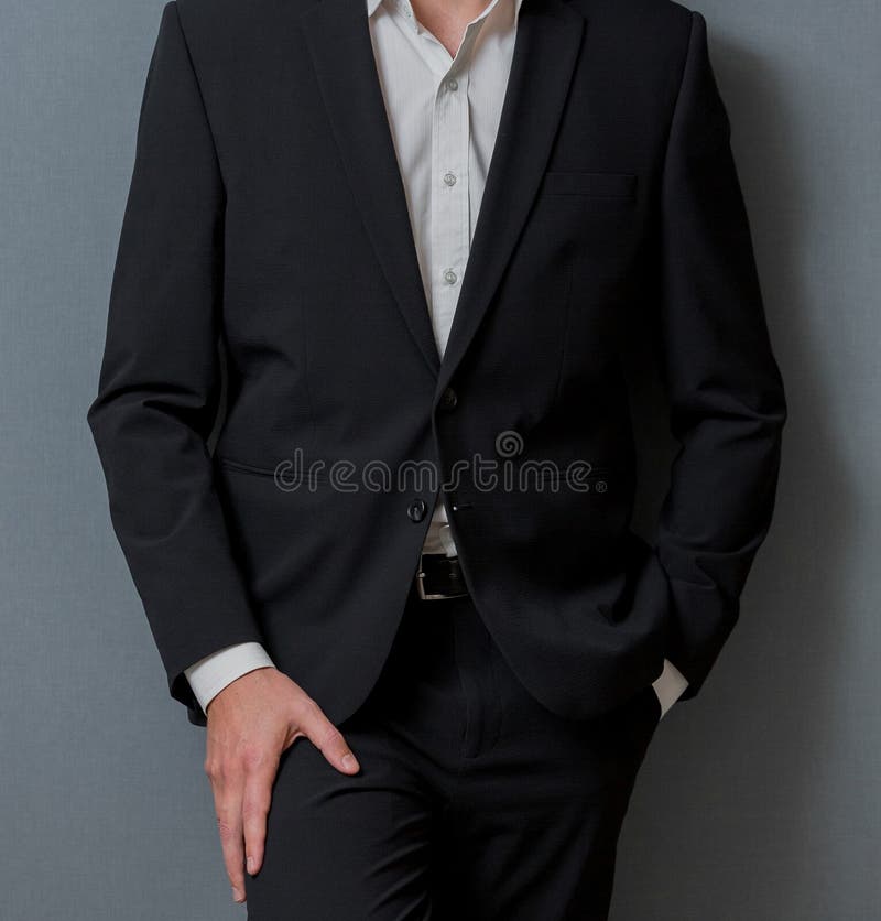 Male in a Classic Black Suit with His Hand in the Pocket Leaning on a ...