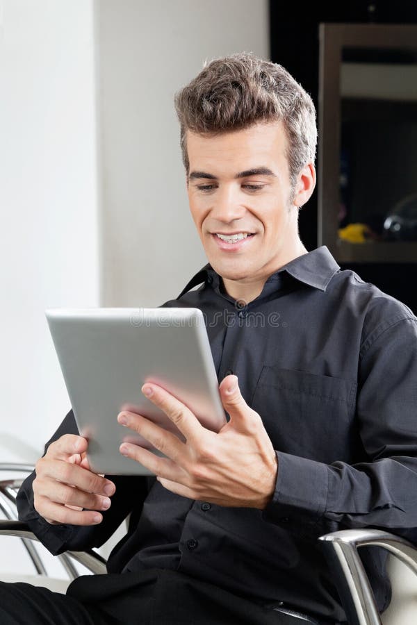 Male Client Using Digital Tablet in Salon Stock Image - Image of ...