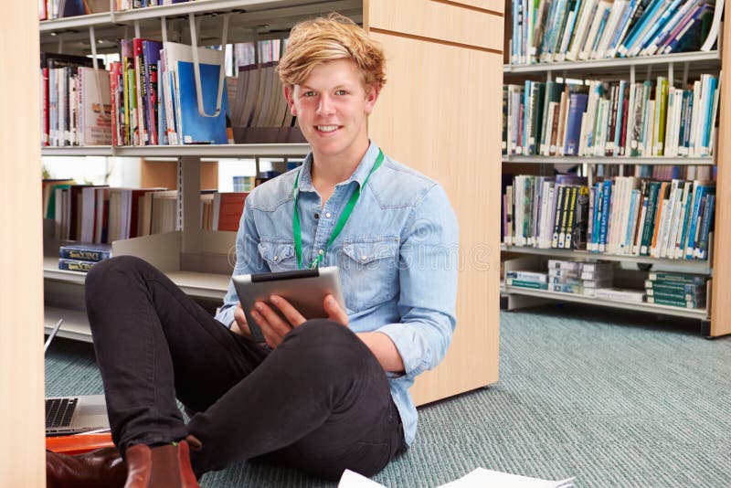 Male College Student Studying in Library with Digital Tablet Stock ...
