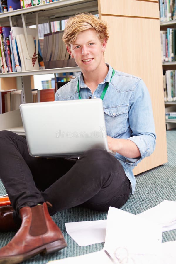 Male College Student Studying in Library with Laptop Stock Image ...