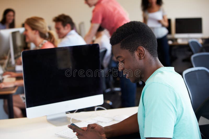 Male College Student Using Mobile Phone in Classroom Stock Image ...