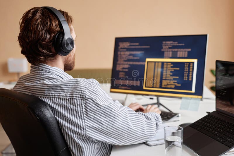 Male Computer Programmer Coding and Wearing Headphones Stock Photo ... Male Computer Programmer Coding and Wearing Headphones Stock Photo ...