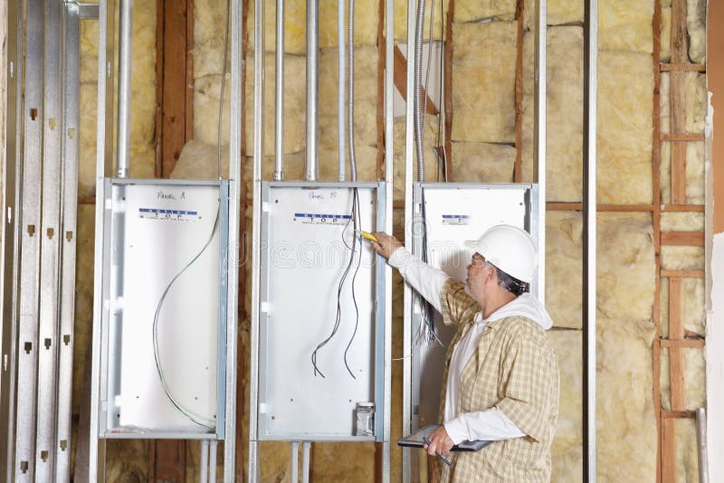 Male Construction Worker Checking Electric Meters at Construction Site ...