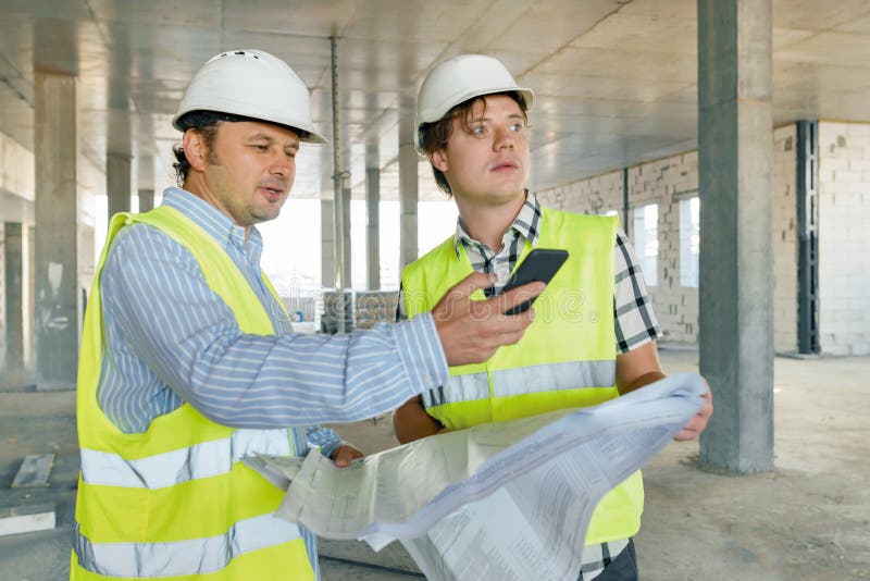 Male Construction Worker and Engineer at the Construction Site ...