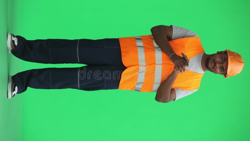 A Male Construction Worker, on a Green Background, in Full Height ...