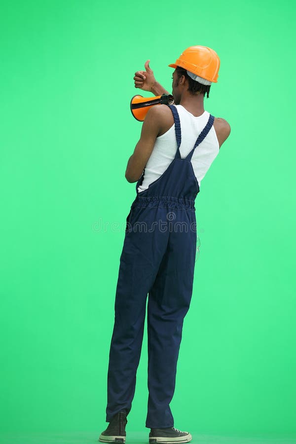 A Male Construction Worker, on a Green Background, in Full Height, with ...