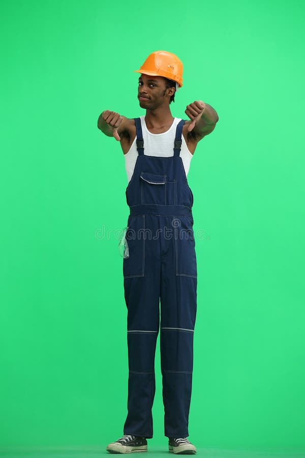 A Male Construction Worker, on a Green Background, in Full Height ...