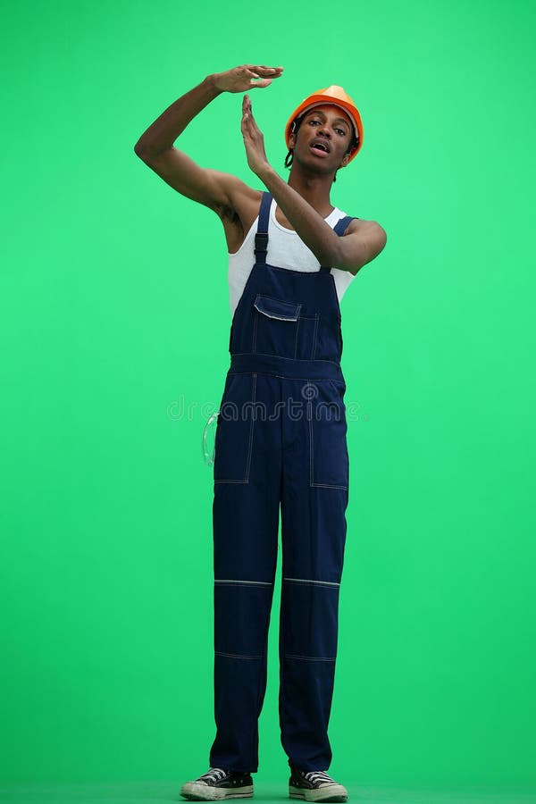 A Male Construction Worker, on a Green Background, in Full Height ...