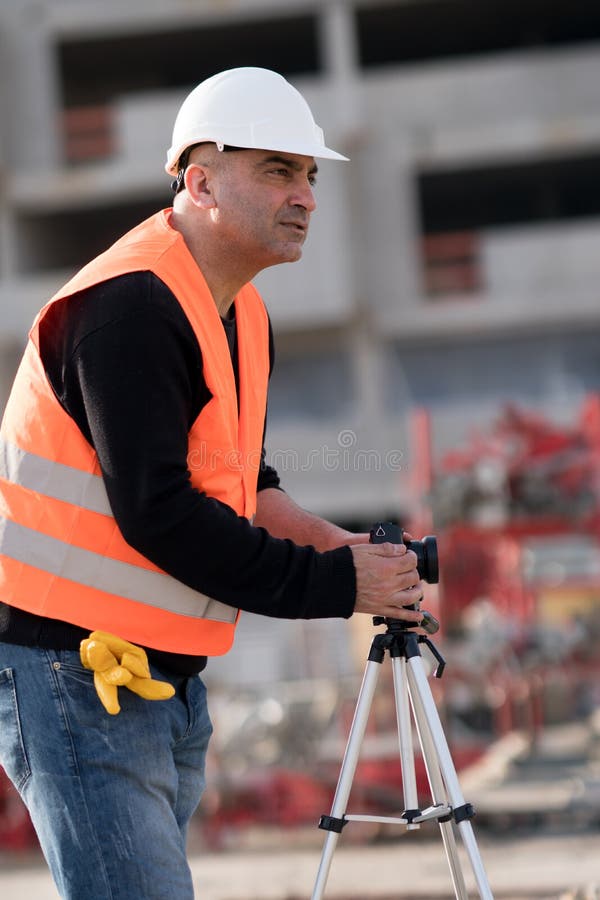 Construction Worker Putting a Digital Camera on Tripod Stock Image ...