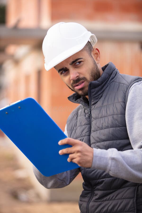 Male Construction Worker Outdoors Writing on Clipboard Stock Image ...