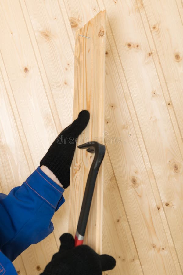 Male Construction Worker Pulls a Nail from the Board with a Special ...
