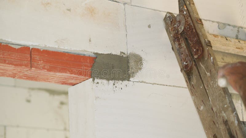 Male Construction Worker Securing Bricks at Door Frame Top Installed in ...