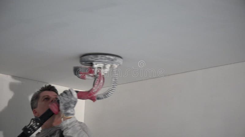 Male Construction Worker Smoothing Ceiling Surface with Sanding Machine ...