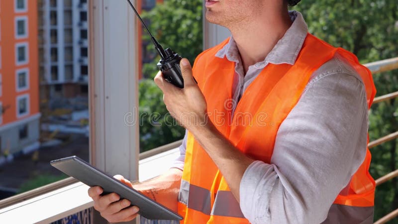 Male Construction Worker Talking on Walkie-talkie at Construction Site ...