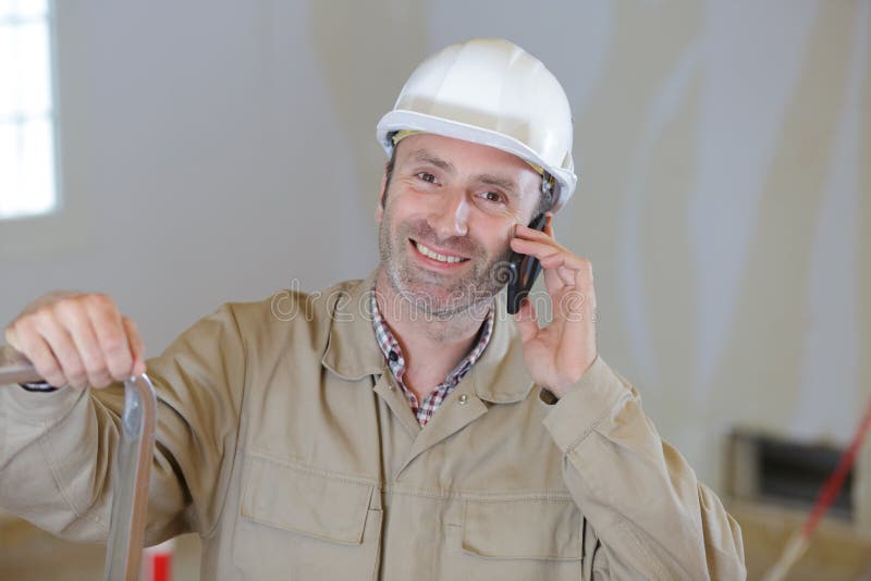 Male Construction Worker Using Cellphone Stock Photo - Image of ...