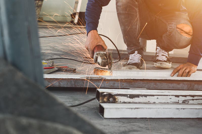 Male Construction Worker Using Electrical Angle Grinder for Cutting ...