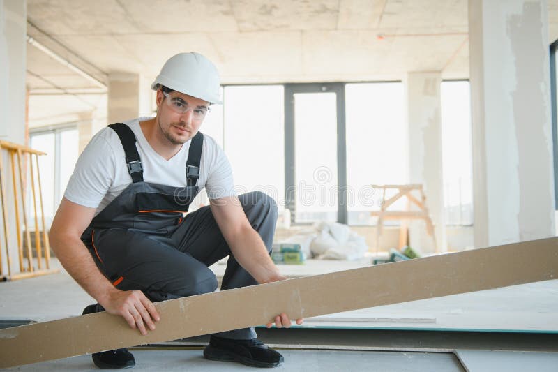 Male Construction Worker Wearing Uniform Install Gypsum Ceiling Inside ...