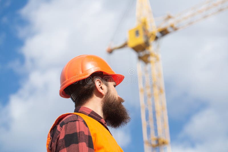 Male Construction Worker in Work Clothes and a Construction Helmet ...