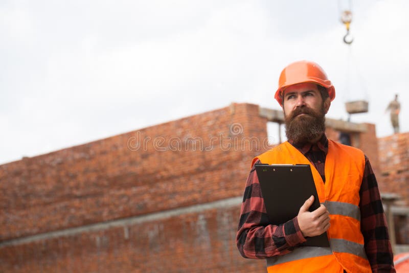Male Construction Worker in Work Clothes and a Construction Helmet ...