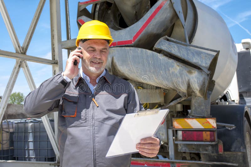 Male Construction Worker with a Yellow Helmet Talking on the Phone ...