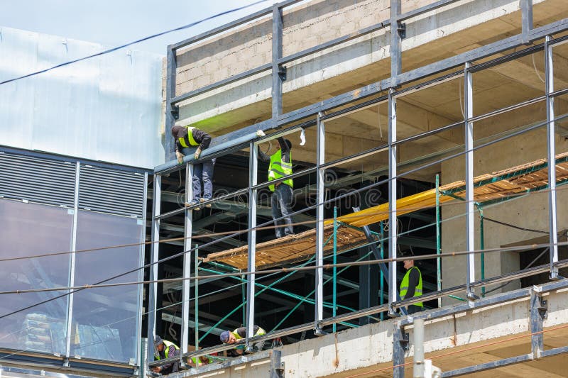 Male Construction Workers are Installing the Iron Frame for the Glazing ...