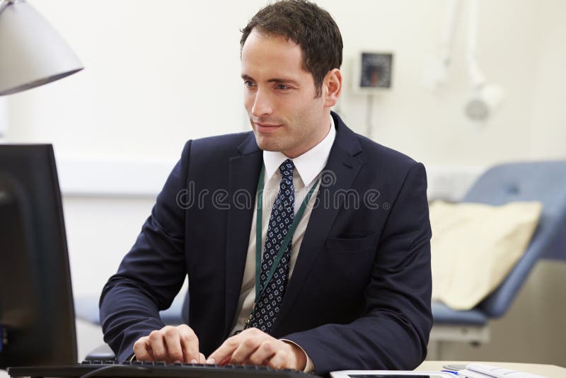 Male Consultant Working at Desk in Office Stock Image - Image of ...
