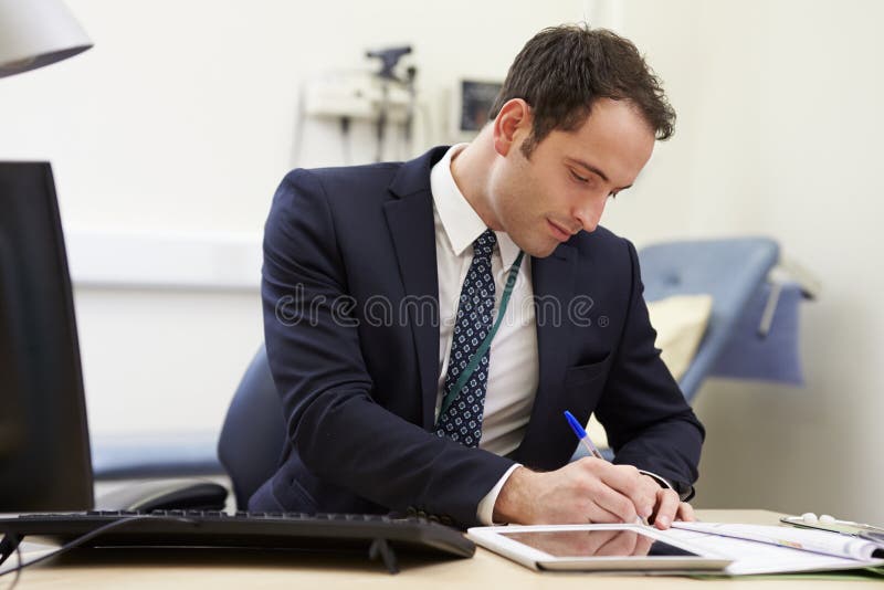 Male Consultant Working at Desk in Office Stock Image - Image of ...