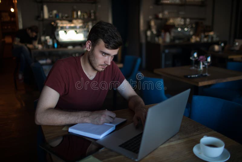 Male Content Writer Using Netbook and Diary for Creating Blog Article ...