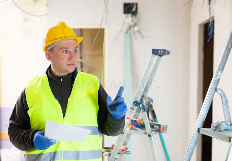 Male Contractor Looking at Room and Determining Scope of Building Work ...