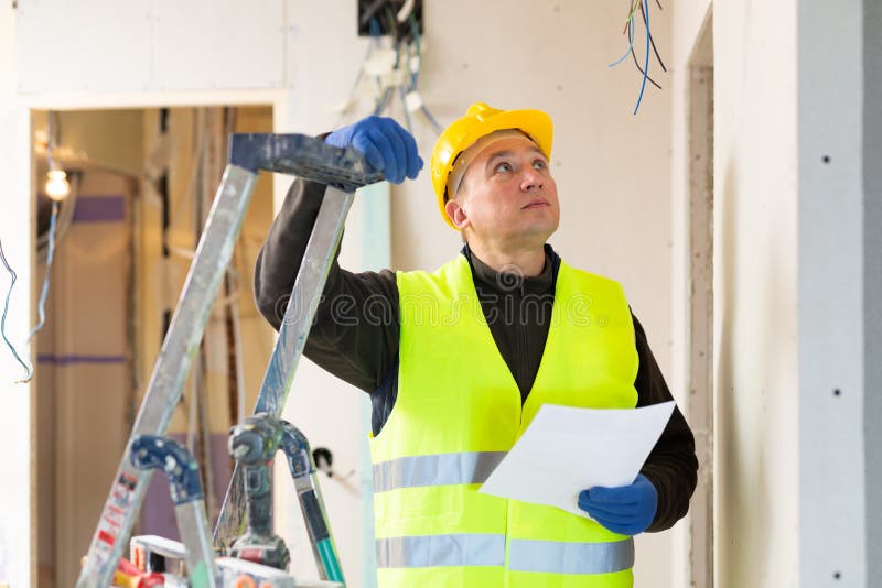 Male Contractor Looking at Room and Determining Scope of Building Work ...